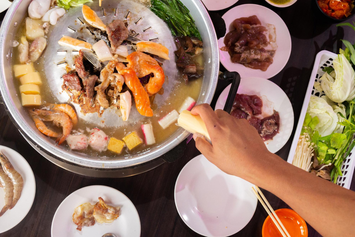 adding tofu to Thai mookata steamboat - Siam Sq Mookata